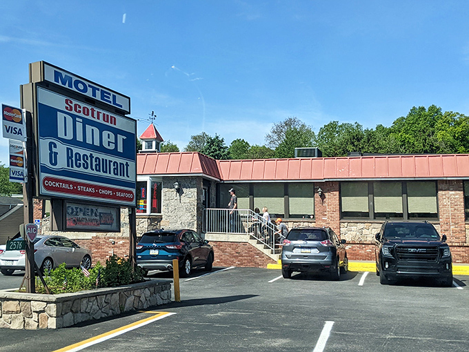The classic roadside sign beckons like an old friend, promising comfort food and a slice of Americana beneath that distinctive copper roof.