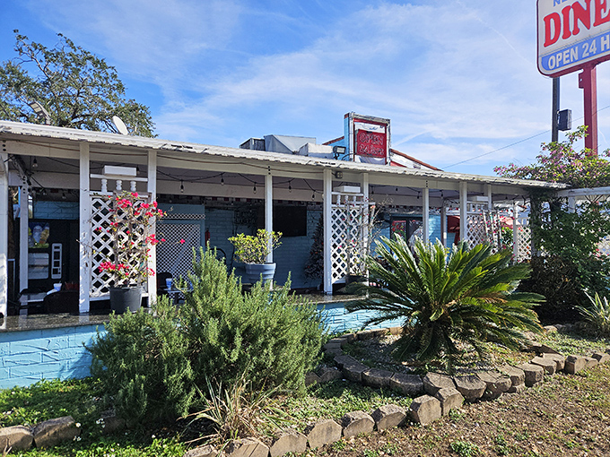 The blue exterior of Joe's New York Diner stands out like a beacon of hope for hungry travelers, promising comfort food with that unmistakable Florida-meets-Manhattan vibe.