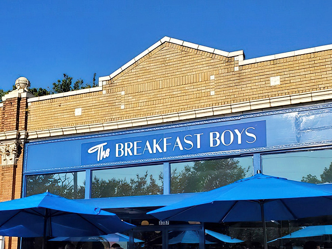 The bright blue exterior of The Breakfast Boys stands out like a culinary beacon in College Park, promising morning delights under those matching umbrellas.