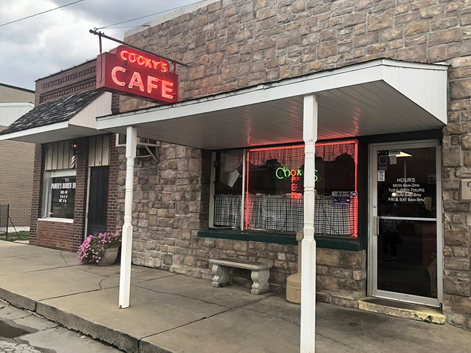 The stone facade and vintage red sign of Cooky's Cafe stand as a time capsule of Americana in Golden City's downtown, welcoming hungry travelers for generations.