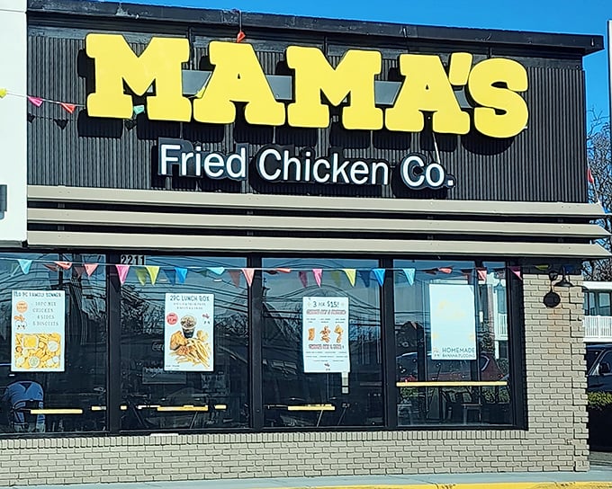 The unmistakable yellow sign beckons like a lighthouse for the hungry. Mama's cartoon chicken mascot practically winks at you, promising crispy delights inside.