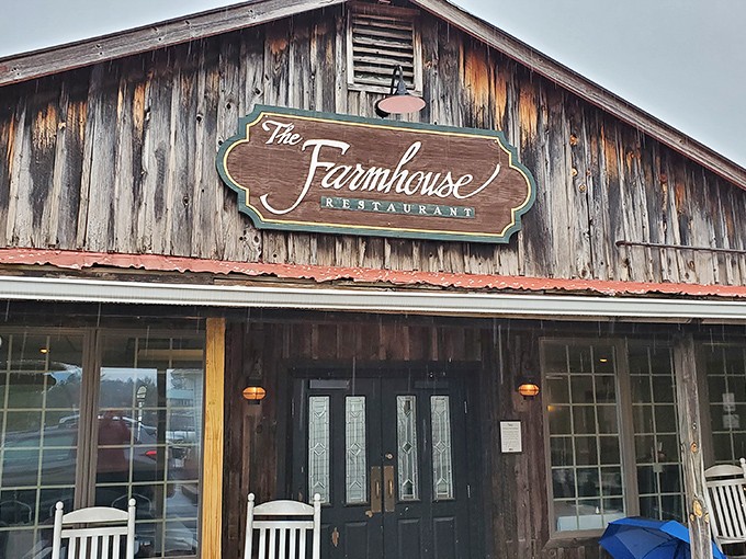 The rustic wooden exterior of The Farmhouse beckons with white rocking chairs and a brick pathway that practically whispers, "Slow down and stay awhile."
