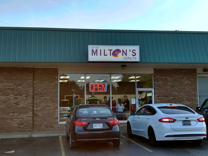 The unassuming storefront of Milton's Donuts, where culinary magic has been happening since 1960. Some architectural wonders hide behind green roofs and brick facades.