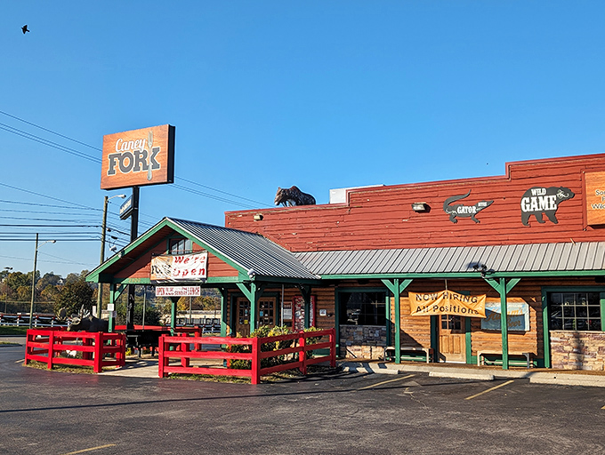 The rustic wooden exterior of Caney Fork beckons with its "Really GOOD FOOD" promise and distinctive red fence &ndash; like a frontier outpost for hungry explorers.