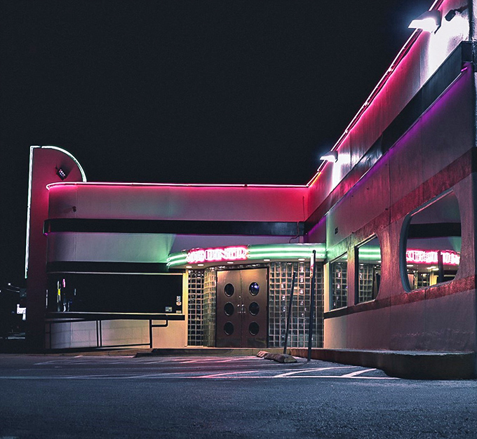 The classic white and black striped exterior of 410 Diner stands like a time capsule on Balcones Drive, promising comfort food treasures within.