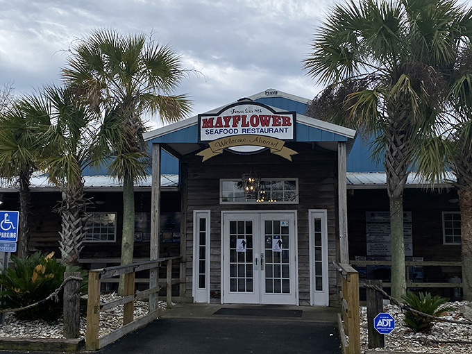 The blue-roofed Mayflower Seafood Restaurant stands like a coastal oasis in Darlington, palm trees welcoming hungry travelers to seafood paradise.