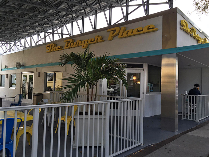 Golden script lettering and palm trees create the perfect Florida diner entrance that whispers "great food ahead."