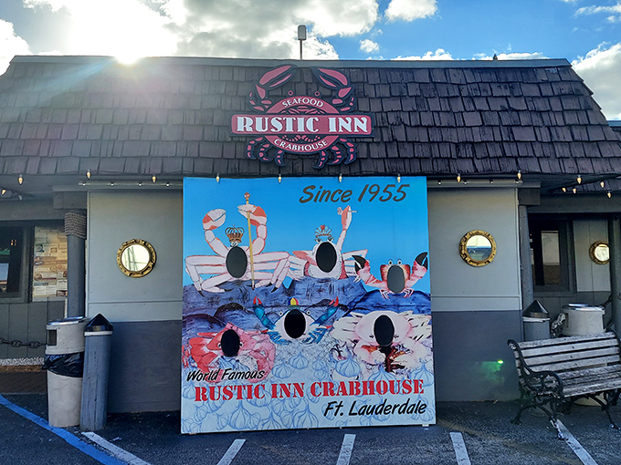 The iconic Rustic Inn Crabhouse exterior beckons seafood lovers with its weathered shingle roof and playful crab photo-op board. Florida dining at its unpretentious best.