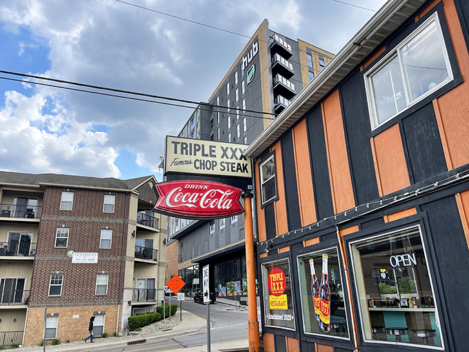 The unmistakable orange and black stripes of Triple XXX stand defiant against modern West Lafayette, like a time machine that happens to serve incredible burgers.