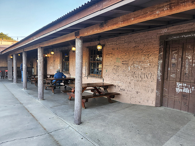 The adobe façade and weathered wooden posts aren't just Instagram-worthy – they're time machines to the Old West, complete with decades of visitor graffiti telling their own stories.