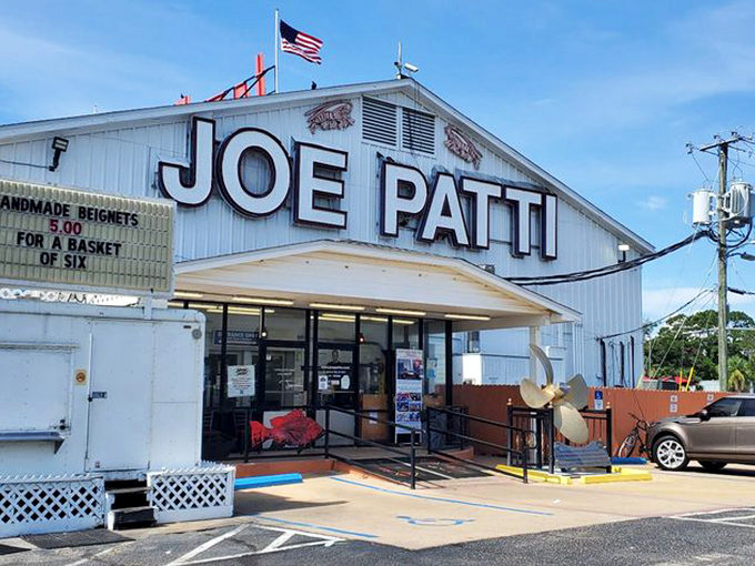 The iconic white building with "JOE PATTI" boldly emblazoned across the top stands like a beacon for seafood lovers along Pensacola Bay.