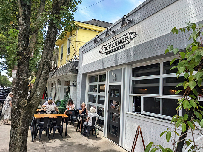 The Governor's crisp white exterior and inviting patio seating create the perfect small-town vibe on Milford's charming Main Street.