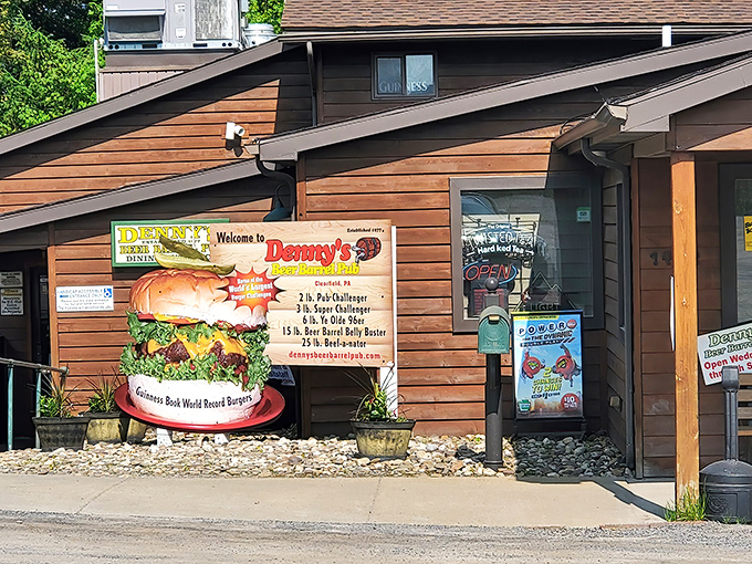 The unassuming wood-sided exterior of Denny's Beer Barrel Pub doesn't hint at the colossal challenges waiting inside, though that burger sign offers a pretty good clue.