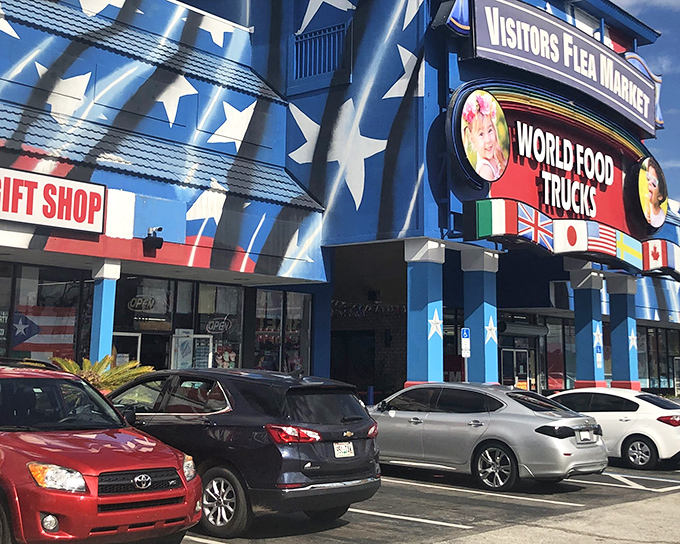The patriotic blue exterior of Visitors Flea Market stands out like Uncle Sam at a beach party, promising international treasures inside its star-spangled walls.