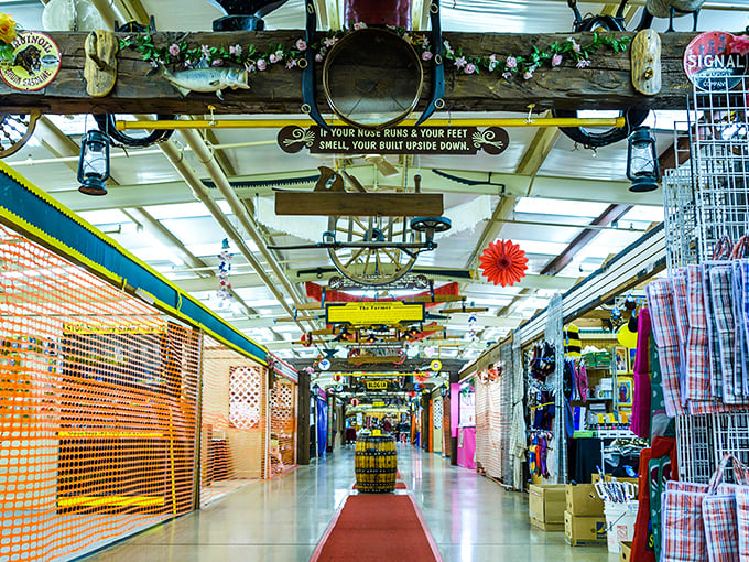 Colorful pennants and vintage treasures line this corridor of discovery, where "just browsing" becomes a three-hour adventure through organized chaos.