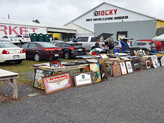 Treasure hunters sift through vintage signs and framed memorabilia while Rocky's hunting gear store stands sentinel in the background. Bargain paradise in its natural habitat!