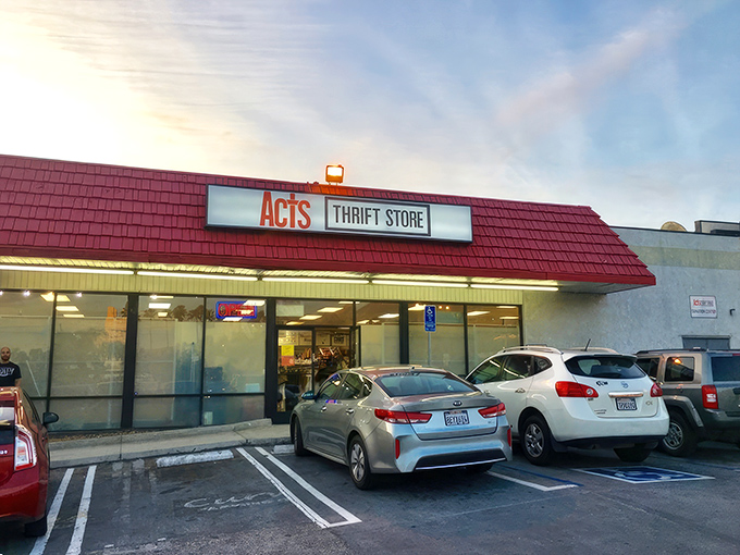 The iconic red roof of ACTS Thrift Store beckons bargain hunters like a lighthouse guiding ships to treasure-filled shores.