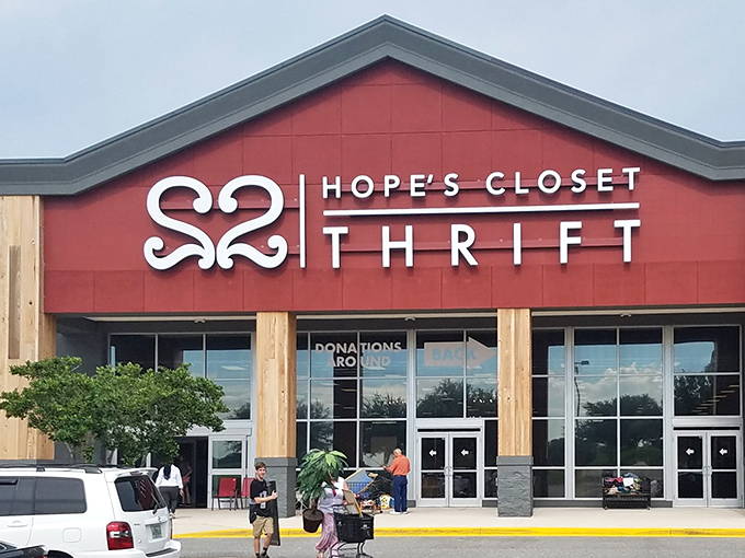The striking red facade of Hope's Closet stands like a beacon for bargain hunters, promising treasures within those spacious walls.