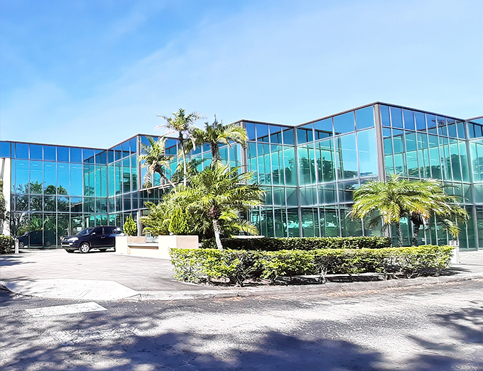 The sleek, modern exterior of American Thrift Store belies the treasure trove within. Palm trees stand guard like sentinels of savings.