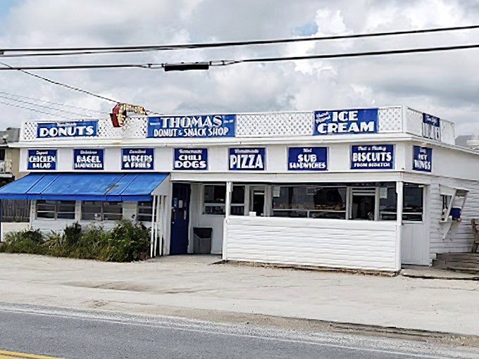The unassuming white building with blue awnings stands like a beacon of sugary hope on Panama City Beach, promising delicious treasures within.