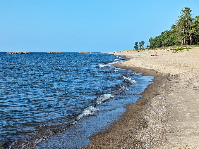 Sandy shores stretch endlessly where Lake Erie meets Pennsylvania's hidden coastal paradise.