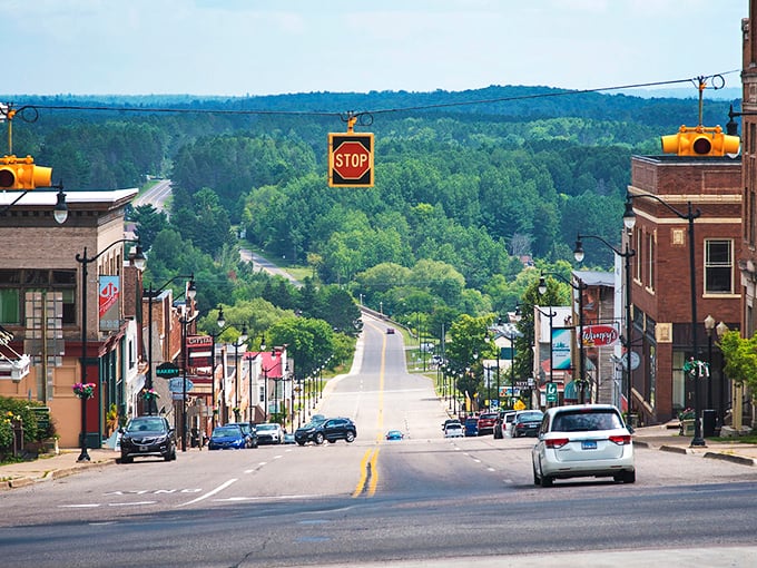 Superior Avenue stretches into the distance like a postcard from simpler times, framed by forests that seem to whisper, "Slow down, you're home now."