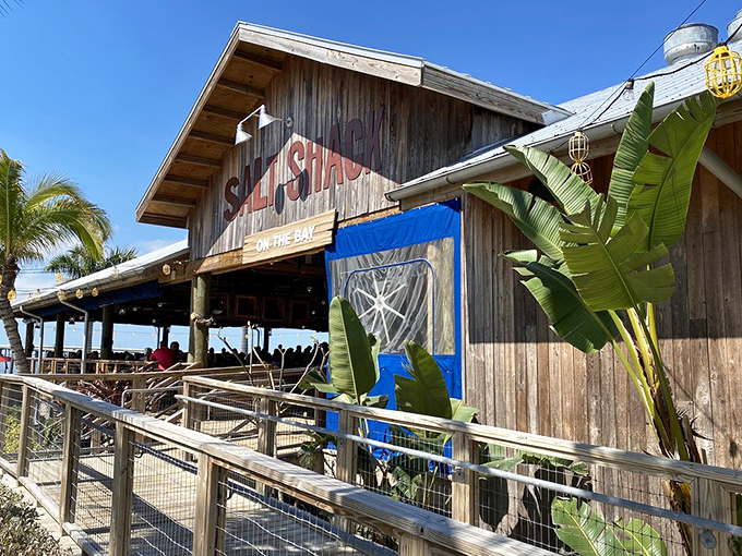 The weathered wooden charm of Salt Shack on the Bay beckons like an old friend, promising Florida sunshine and seafood treasures within.
