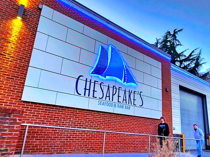 The blue neon sailboat sign beckons like a lighthouse for hungry travelers. Chesapeake's brick exterior promises seafood salvation in the heart of mountain country.