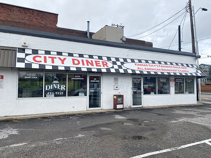 The checkered awning beckons like a black-and-white flag signaling "good food ahead." City Diner's unassuming exterior promises authentic diner magic within.