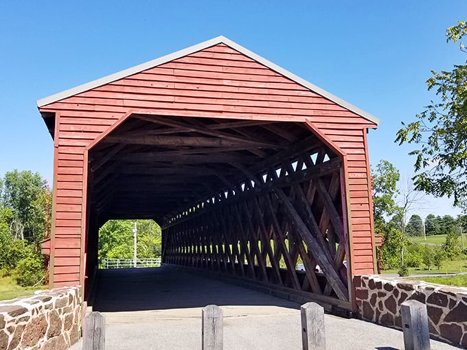 The iconic red exterior of Sachs Bridge welcomes visitors with its Town truss design. History and haunting tales await inside this 170-year-old Gettysburg landmark.