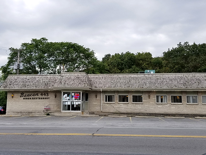 The classic roadside sign beckons like an old friend. Beacon 443's weathered charm promises honest food without pretension.