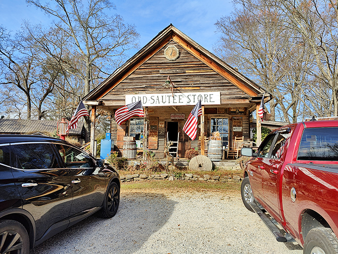The Old Sautee Store stands proudly against the Georgia sky, its weathered wooden facade and inviting porch practically whispering tales from another century.