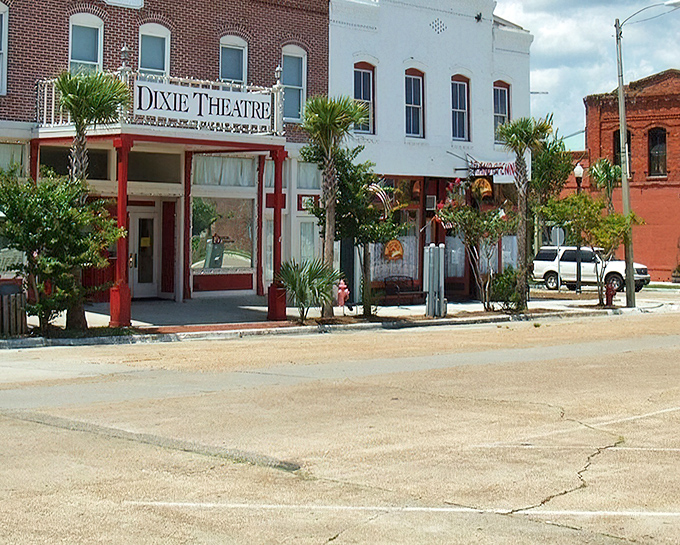 The historic Dixie Theatre stands as Apalachicola's cultural heartbeat, where brick facades and palm trees create that perfect "Old Florida" postcard moment.