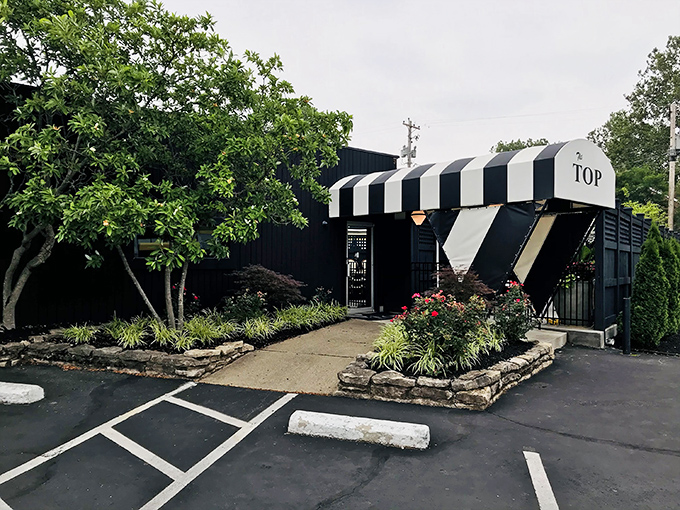 The iconic entrance to The Top Steakhouse stands like a mid-century modern beacon for carnivores, promising meaty delights within its hallowed walls.