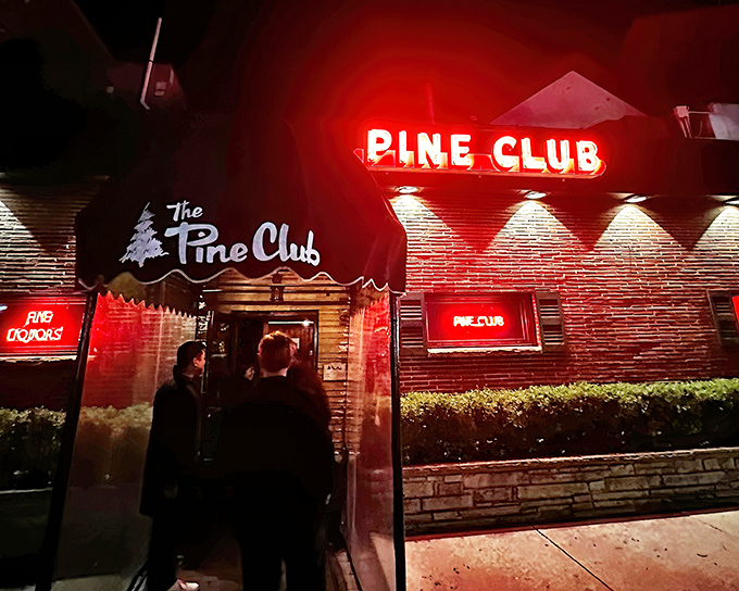 The neon glow of The Pine Club sign has been beckoning hungry Daytonians for decades, a red-lit promise of carnivorous delights within.