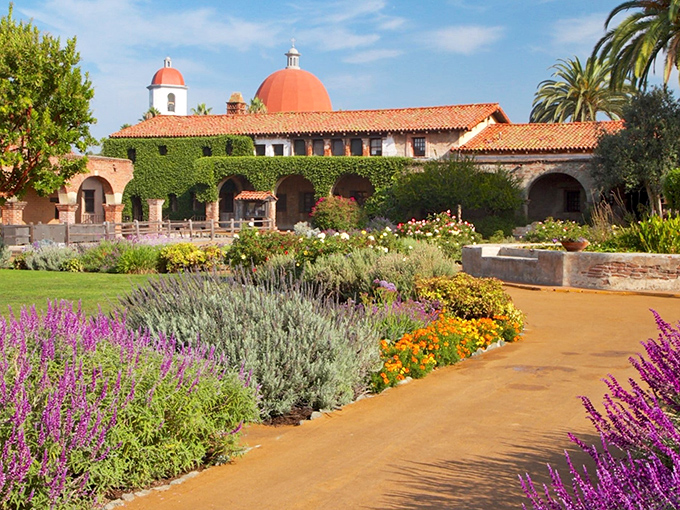 The Mission's gardens bloom with such vibrant colors, it's like Mother Nature decided to throw California's most photogenic garden party.
