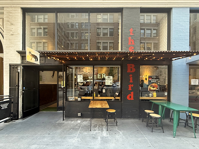 The Bird's unassuming storefront in San Francisco's Financial District beckons with its yellow cat logo—like a culinary lighthouse guiding hungry souls to fried chicken paradise.