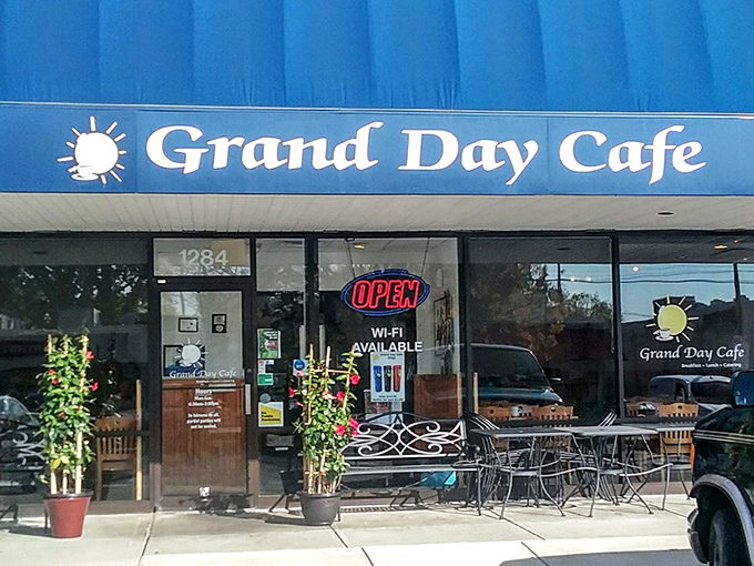 The classic blue awning of Grand Day Cafe stands as a beacon of breakfast hope in this Columbus strip mall&mdash;proof that culinary treasures often hide in plain sight.