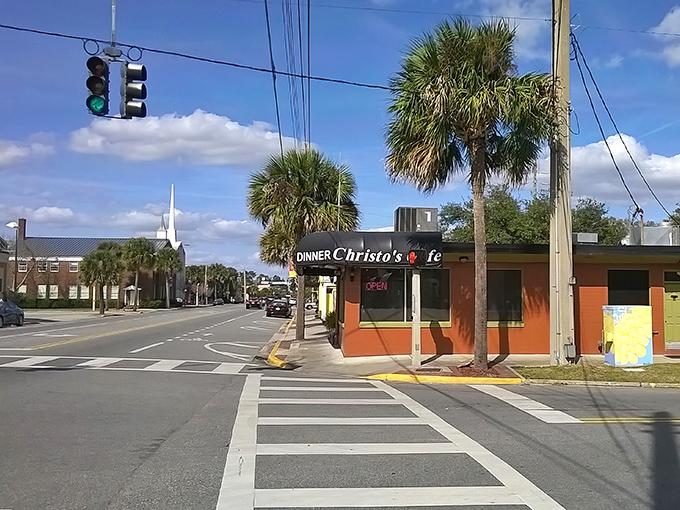 The unassuming orange exterior of Christo's Café stands like a beacon of breakfast hope on Edgewater Drive, palm trees standing guard over this Orlando treasure.