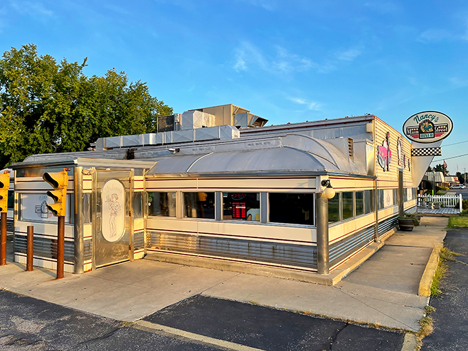 The classic stainless steel exterior of Nancy's Main Street Diner gleams in the sunlight, a time capsule of Americana waiting to feed hungry souls.