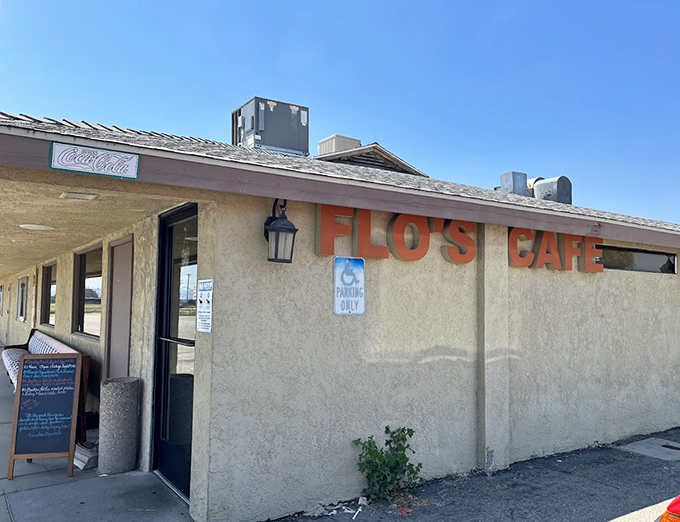 The unassuming exterior of Flo's Airport Cafe stands like a time capsule at Chino Airport, promising comfort food that's been fueling pilots and locals for generations.