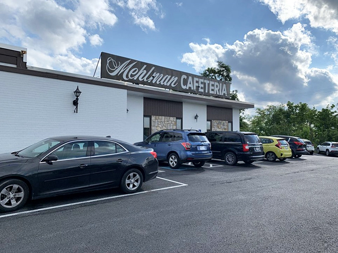The unassuming white exterior of Mehlman Cafeteria stands like a culinary time capsule, promising comfort food treasures within those brick walls.