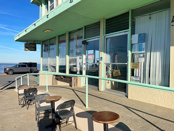 The mint-green facade of Chit Chat Cafe stands like a sentry at the edge of the Pacific, promising simple pleasures and ocean views that million-dollar restaurants can't buy.