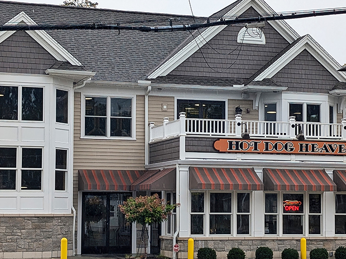 The welcoming exterior of Hot Dog Heaven stands like a beacon of comfort food in Amherst, complete with charming striped awnings that practically whisper "come get your chili dog fix."