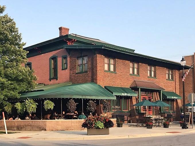The Willard's brick exterior with its signature green awnings stands as Franklin's culinary lighthouse, beckoning hungry travelers with promises of Hoosier hospitality.