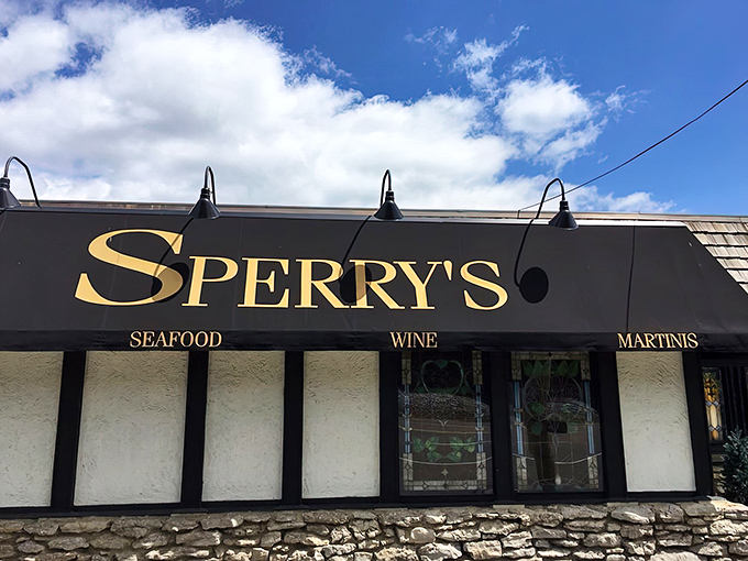 The iconic Tudor-style exterior of Sperry's stands like a culinary lighthouse in Belle Meade, beckoning hungry Nashvillians with its distinctive red and white sign.