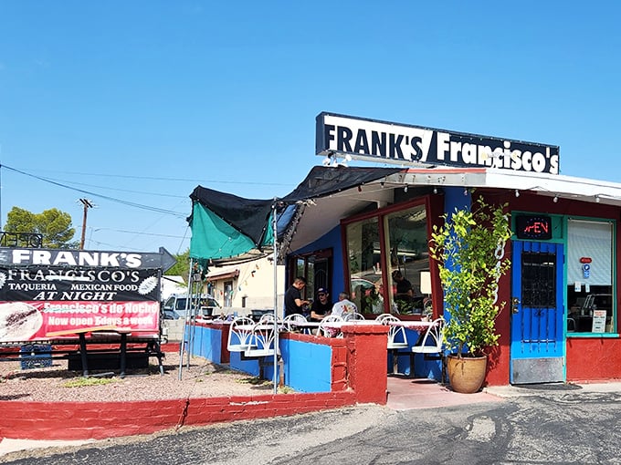 The vibrant red and blue exterior of Frank's/Francisco's stands like a colorful oasis in Tucson, promising authentic Mexican flavors behind that unassuming blue door.