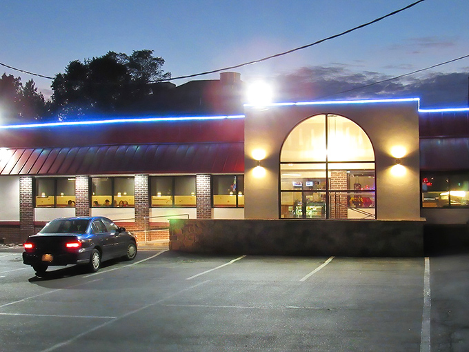 The blue neon glow of Black Olive Family Diner beckons hungry travelers like a lighthouse for the famished. Classic diner architecture with a modern twist. 