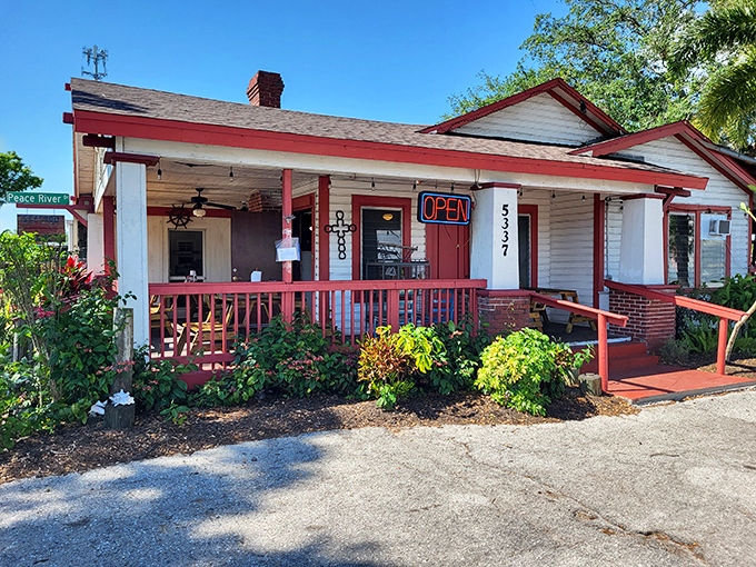 A classic Florida cracker house transformed into seafood heaven. The red-trimmed porch practically whispers "come on in" to hungry passersby.