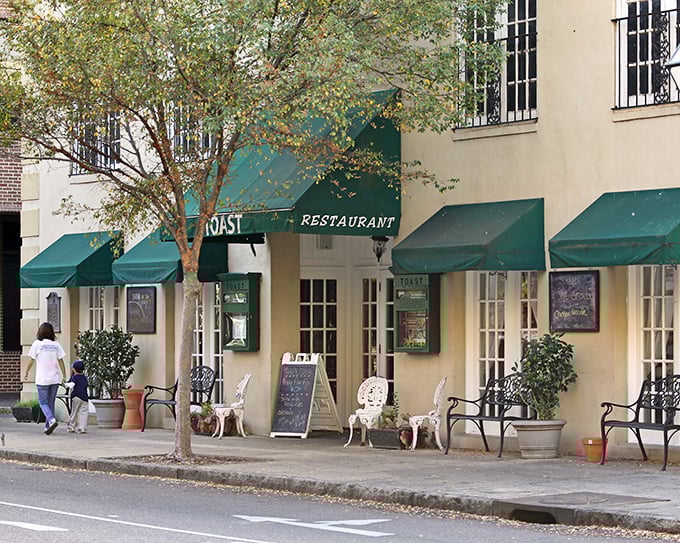 Those green awnings whisper promises of breakfast bliss hiding behind Charleston's most unassuming storefront.